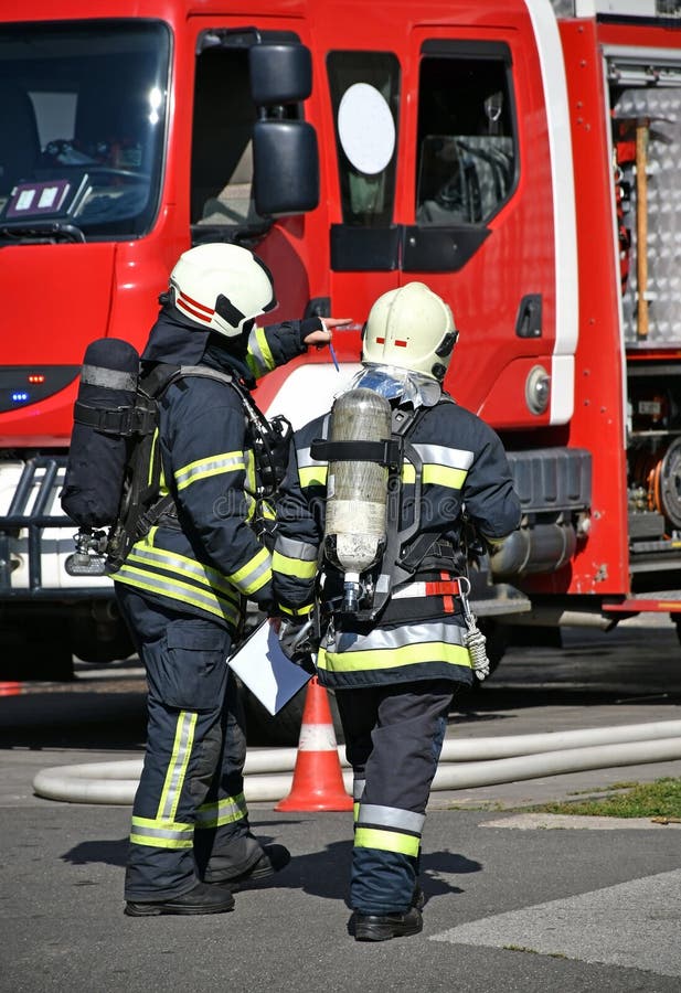 Firefighter at the Scene of a Fire Stock Image - Image of reel, tank ...