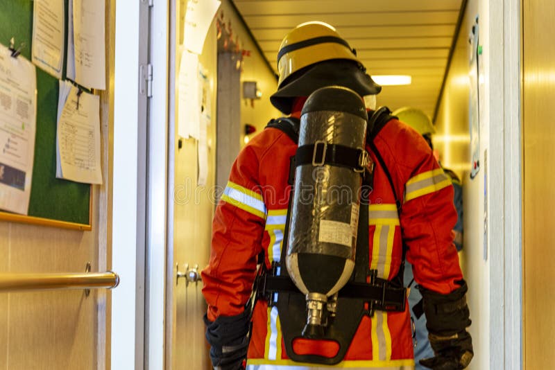 Firefighter in Full Gear with Oxygen Cylinder Heading into Fire Stock ...