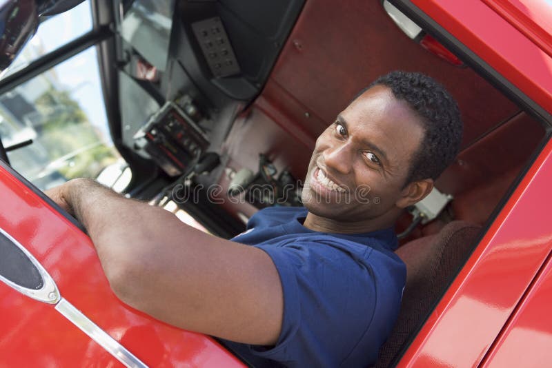 A Firefighter Sitting in the Cab of a Fire Engine Stock Image - Image ...