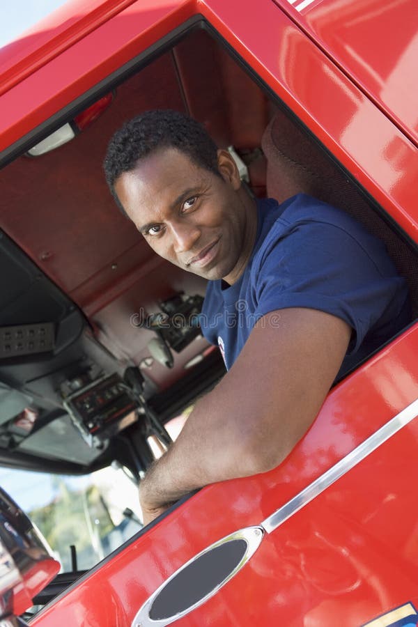 A Firefighter Sitting in the Cab of a Fire Engine Stock Image - Image ...