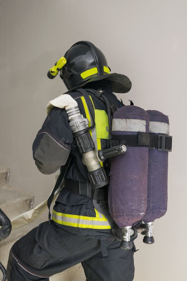 Firefighter in Special Clothes Holds a Sleeve Line, Back View Stock ...