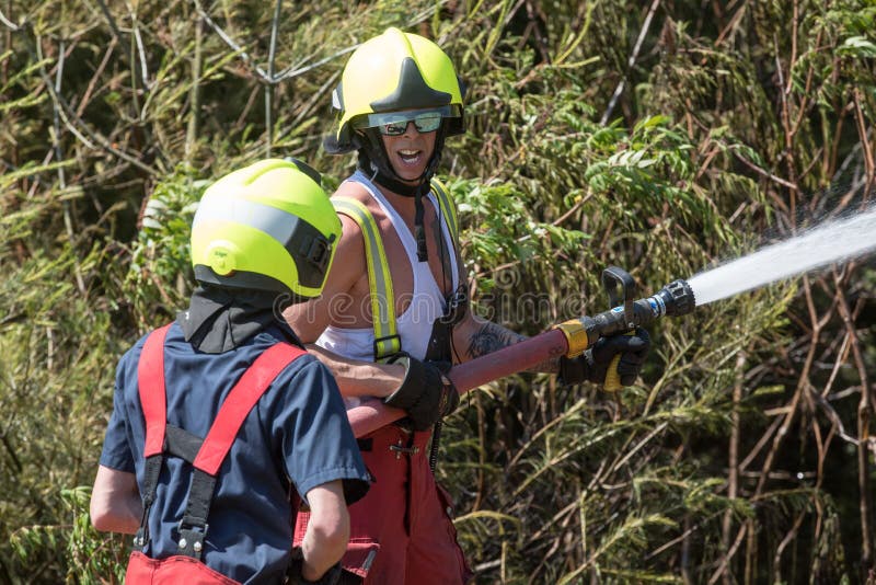 Firefighter Spray Water on Wall with Hose. Editorial Photo - Image of ...