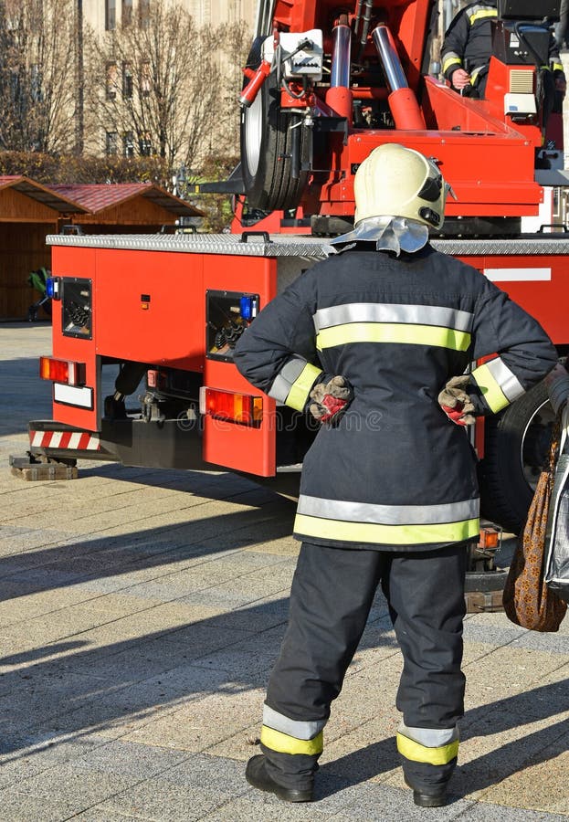Firefighter Stands Next To a Crane Stock Photo - Image of occupation ...