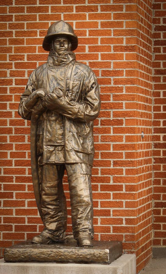 Firefighter Statue with Sky and Clouds in the Background Stock Image ...