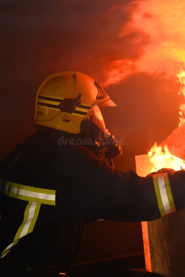 Firefighter Tackles Flames in a Burning Building. Editorial Photo ...