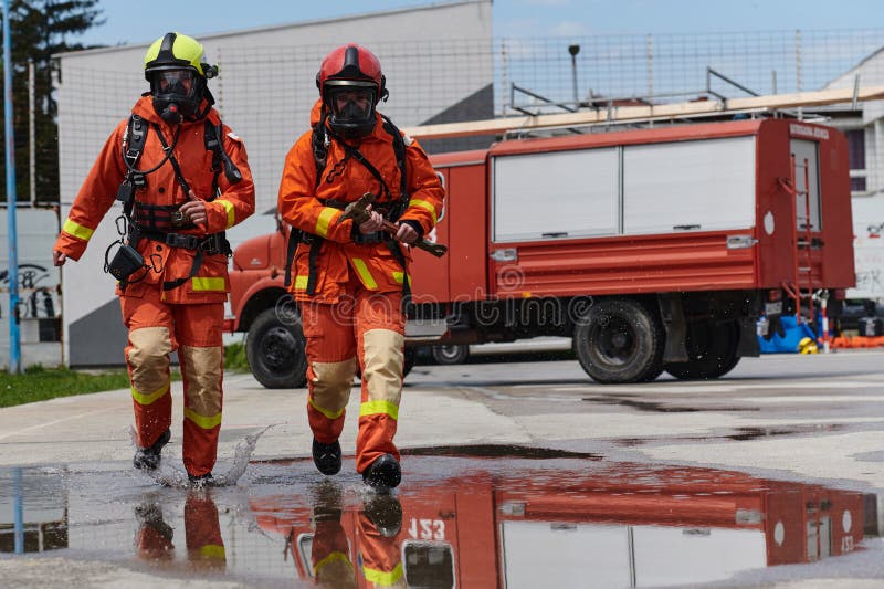 Firefighter Team Training with Various Tools in Professional Gear Stock ...
