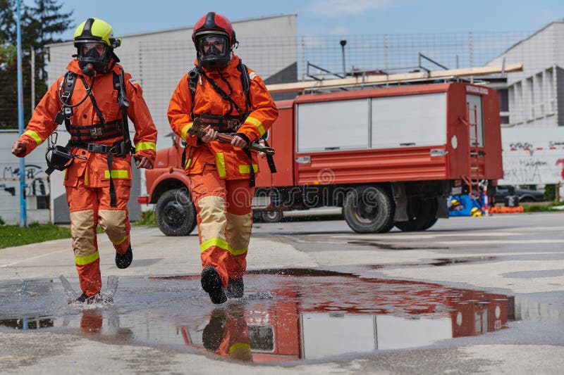 Firefighter Team Training with Various Tools in Professional Gear Stock ...