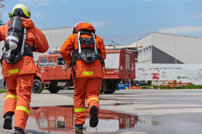 Firefighter Team Training with Various Tools in Professional Gear Stock ...