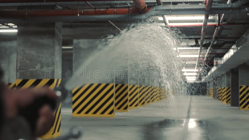 A Firefighter is Testing the Fire Safety System. Test Start of Water ...