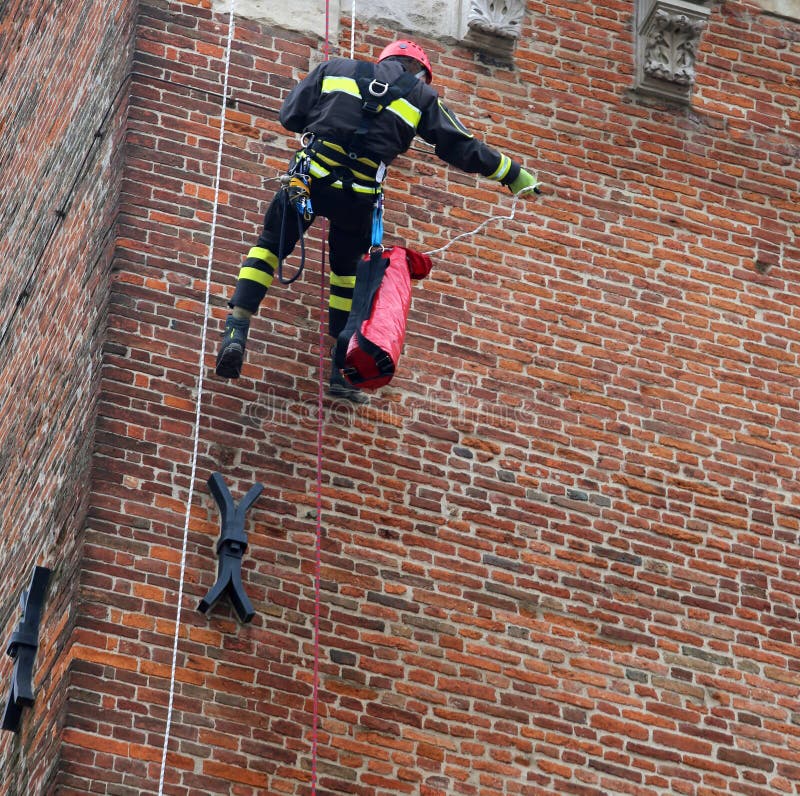 Firefighter during a Training Exercise Climbing on Old Brick Med Stock ...