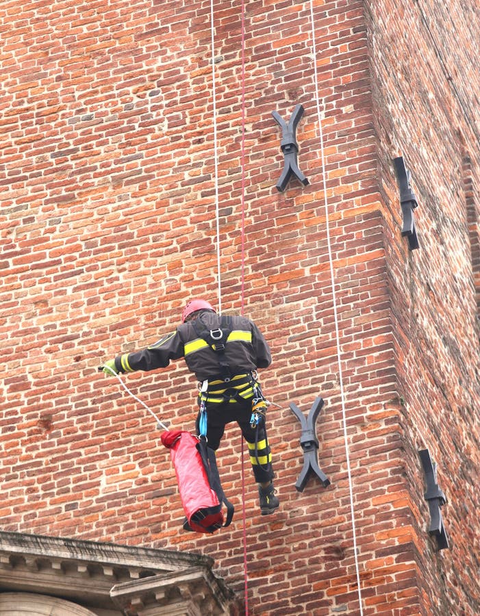 Firefighter during a Training Exercise Climbing on Old Brick Med Stock ...