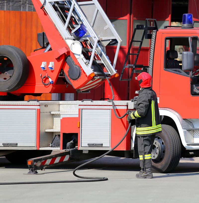 Firefighter with Truck Fire Engines in Fire Department Station Stock ...