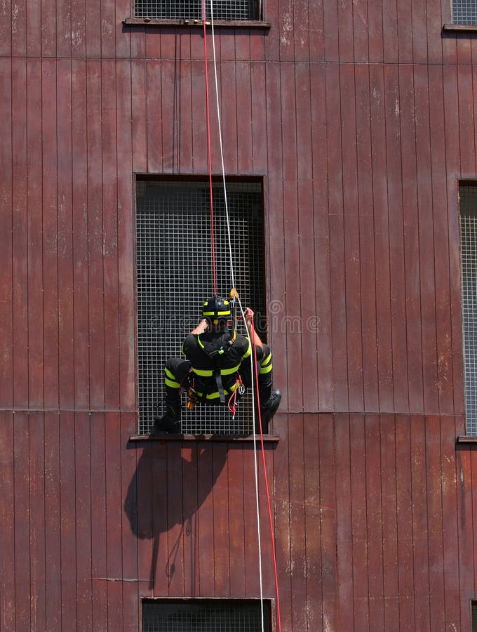 Firefighter in Uniform Rappelling Down Building during Fire Station ...