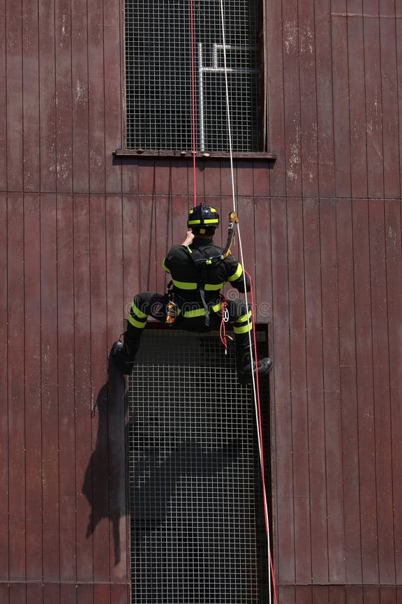 Firefighter and Uniform Rappelling Down Building during Training ...