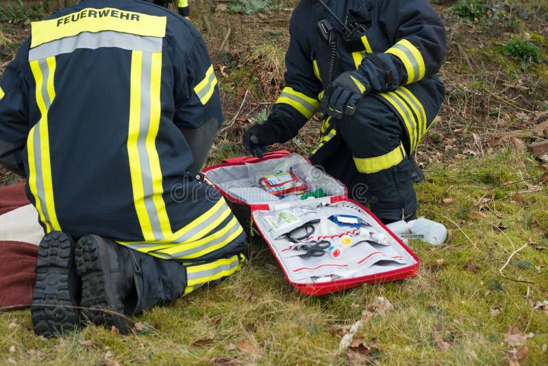 Firefighter in Use with First Aid Kit - Serie Firefighter Stock Image ...