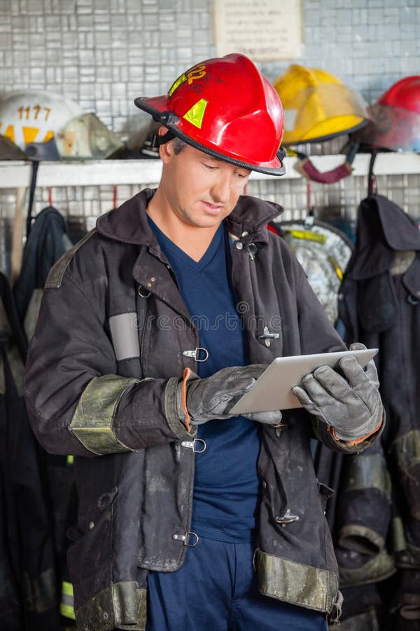 Firefighter Using Digital Tablet at Fire Station Stock Photo - Image of ...