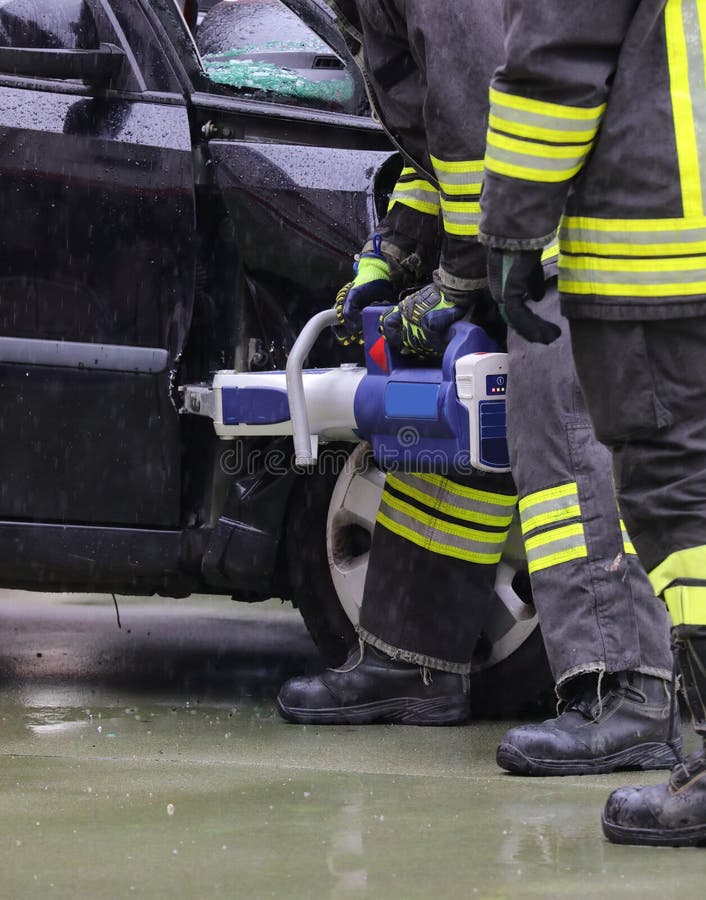 Firefighter Using Powerful Cordless Pneumatic Shears To Open the Jammed ...
