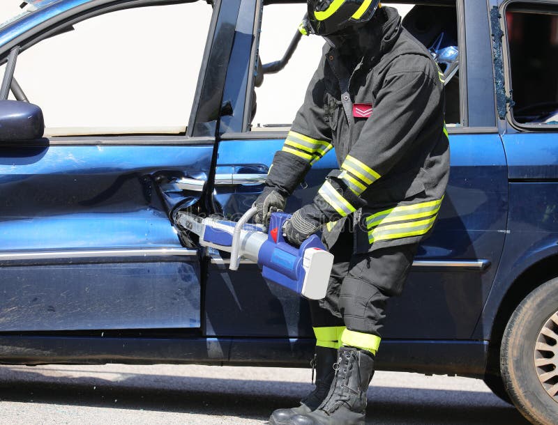 Firefighter Using Powerful Pneumatic Shears To Open the Jammed Door of ...