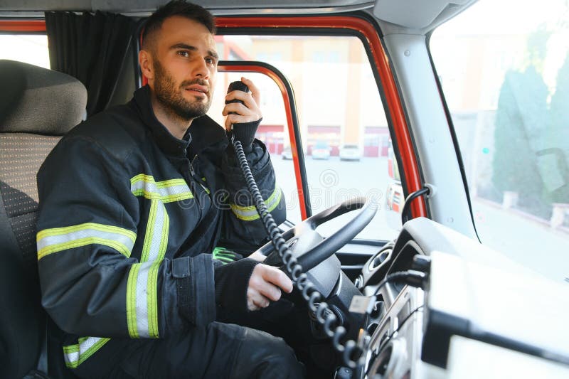 Firefighter Using Radio Set while Driving Fire Truck Stock Photo ...