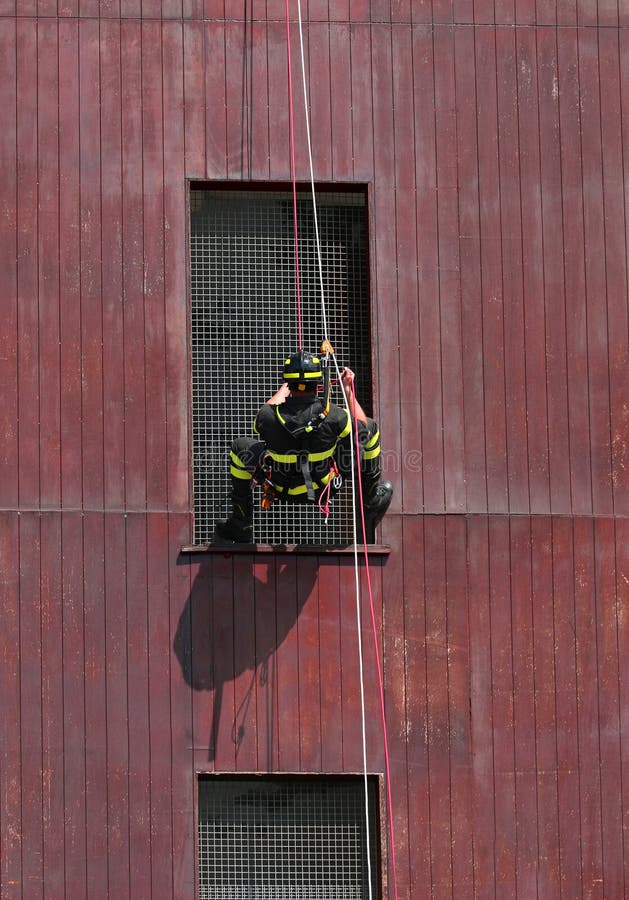 Firefighter Using a Safety Harness with Carabiners for Descending a ...