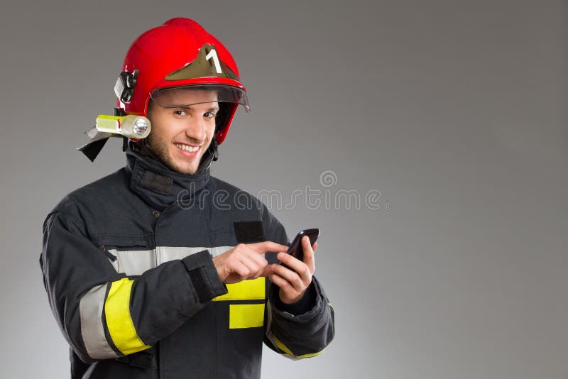 Firefighter Using Smart Phone. Stock Photo - Image of equipment, coat ...