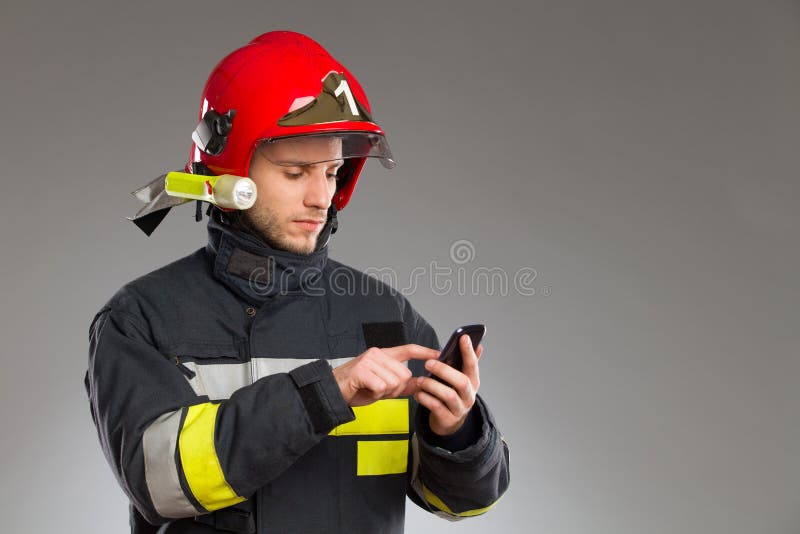 Firefighter Using Smart Phone. Stock Image - Image of occupation ...