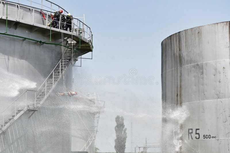 Firefighter Water Jet on Big Storage Tank Stock Photo - Image of hose ...