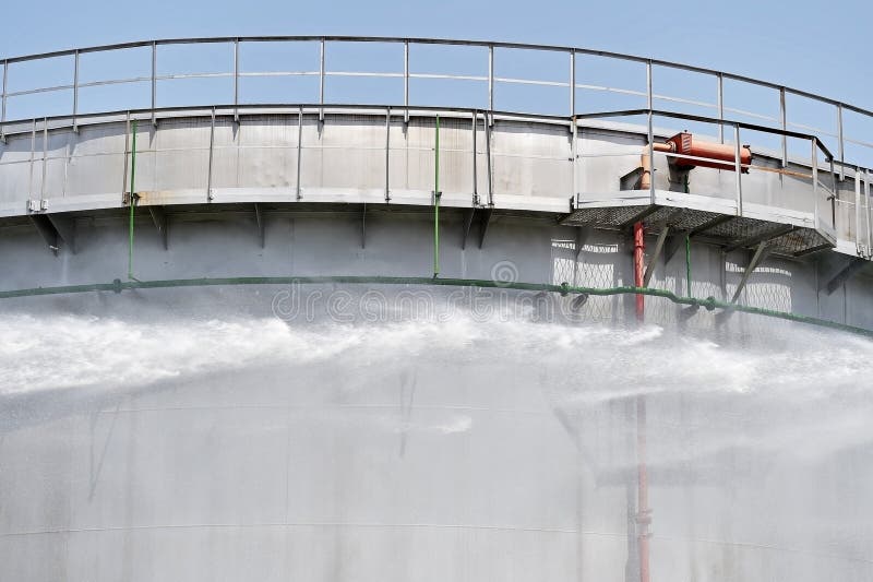 Firefighter Water Jet on Big Storage Tank Stock Photo - Image of water ...