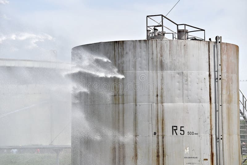 Firefighter Water Jet on Big Storage Tank Stock Photo - Image of silo ...