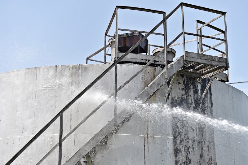 Firefighter Water Jet on Big Storage Tank Stock Image - Image of ...