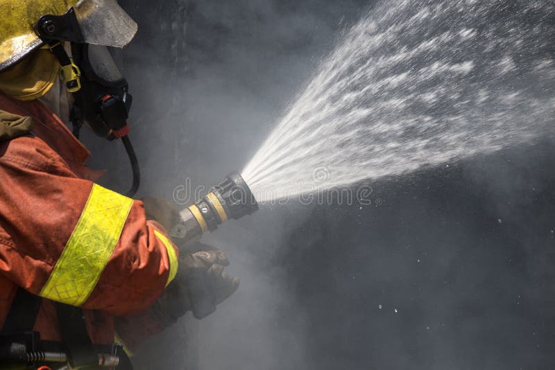 Firefighter Water Spray by High Pressure Fire Hose Stock Image - Image ...