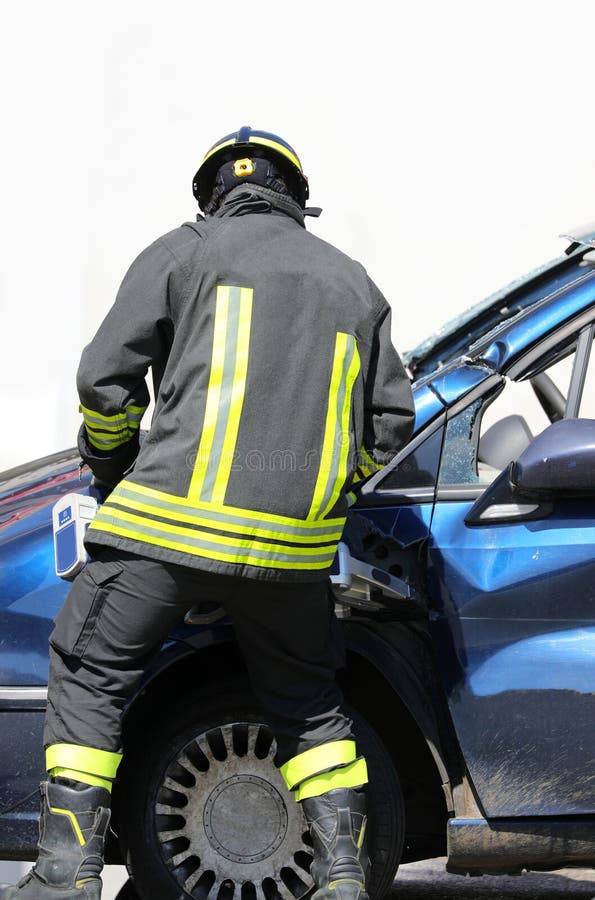 Firefighter Wearing a Uniform is Using Hydraulic Shears Stock Photo ...