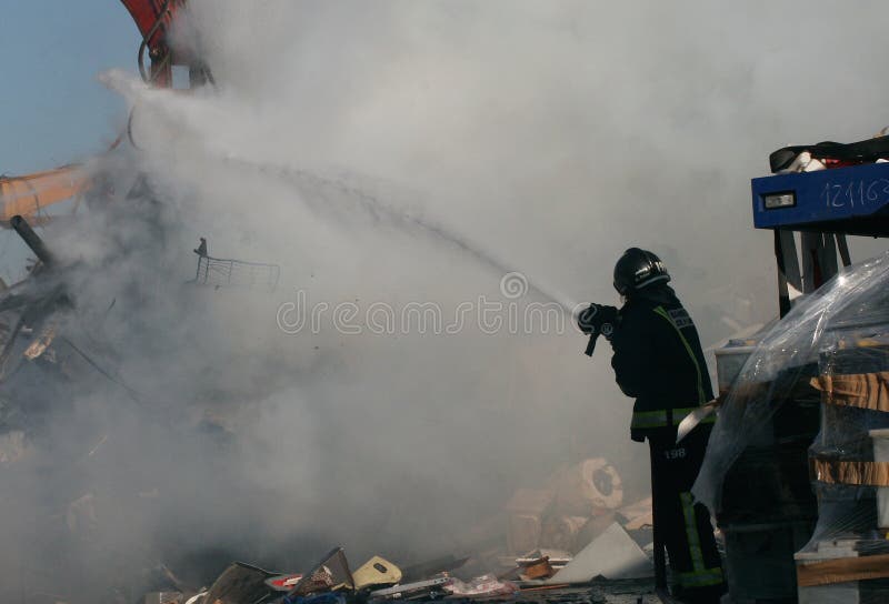 Firefighter Working on Industrial Fire at Junk Yard Editorial Image ...