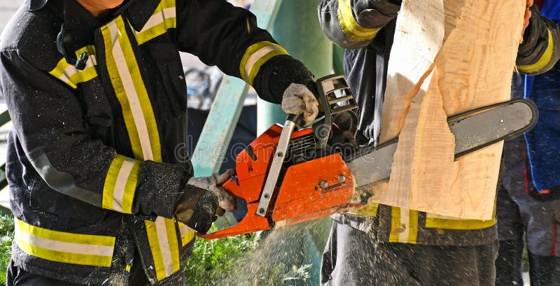 Firefighter Works with a Chainsaw Outdoor Stock Photo - Image of ...
