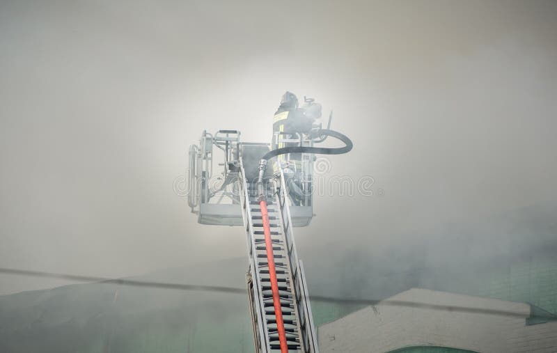 Firefighters in Action Fighting, Extinguishing Fire, in Smoke. Stock ...