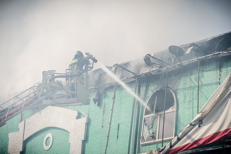 Firefighters in Action Fighting, Extinguishing Fire, in Smoke. Stock ...