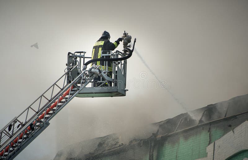 Firefighters in Action Fighting Fire Stock Photo - Image of helmets ...