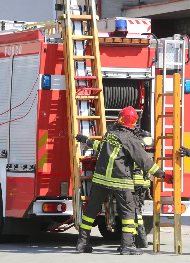 Firefighters in Action Take the Wooden Ladder Stock Photo - Image of ...