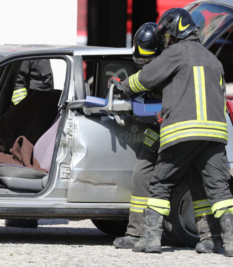 Firefighters with Shears Open the Car Doors after a Serious Car Stock ...