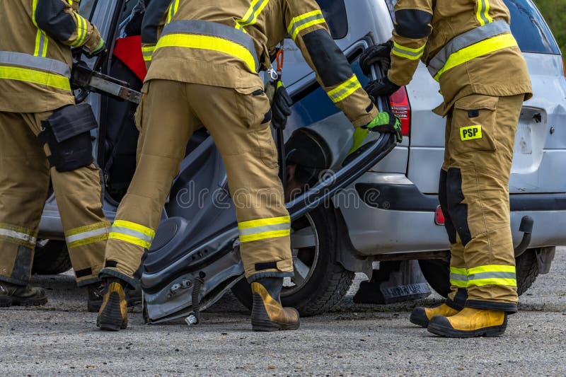 Firefighters Cutting the Body of a Car after an Accident Stock Photo ...