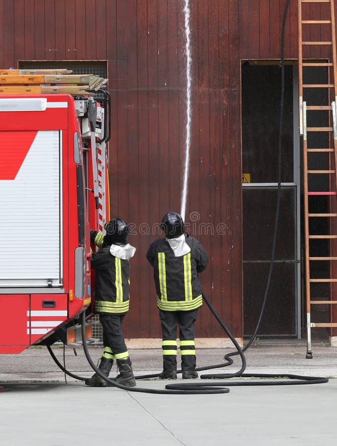 Firefighters Engaged with a Fire Hydrant To Put Out the Stock Photo ...