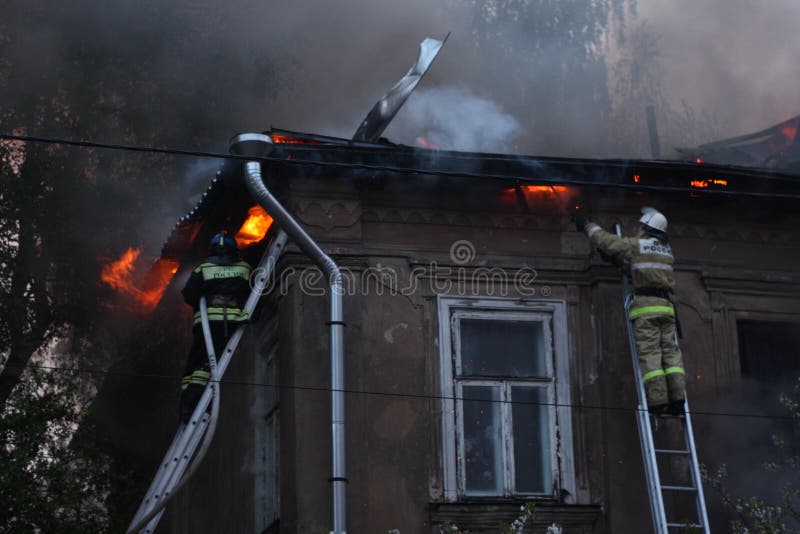 Firefighters Extinguish a Fire in an Old House Stock Photo - Image of ...