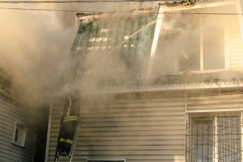 Firefighters Extinguish a Large House Fire in Smoke Stock Image - Image ...