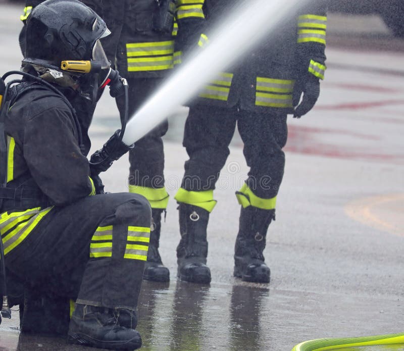 Firefighters Extinguishing a Blaze with a Powerful Foam Jet while ...