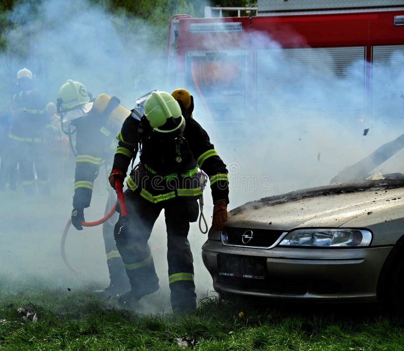 Firefighters Extinguishing a Burning Car Editorial Stock Image - Image ...