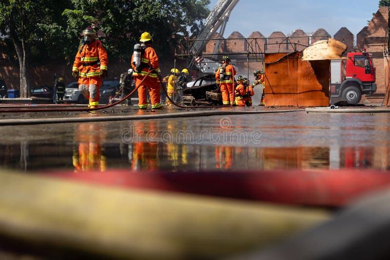 Brave Firefighter Using Extinguisher and Water from Hose for Fire ...