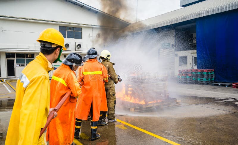 Two Firefighters Fighting a Fire Stock Image - Image of protective ...