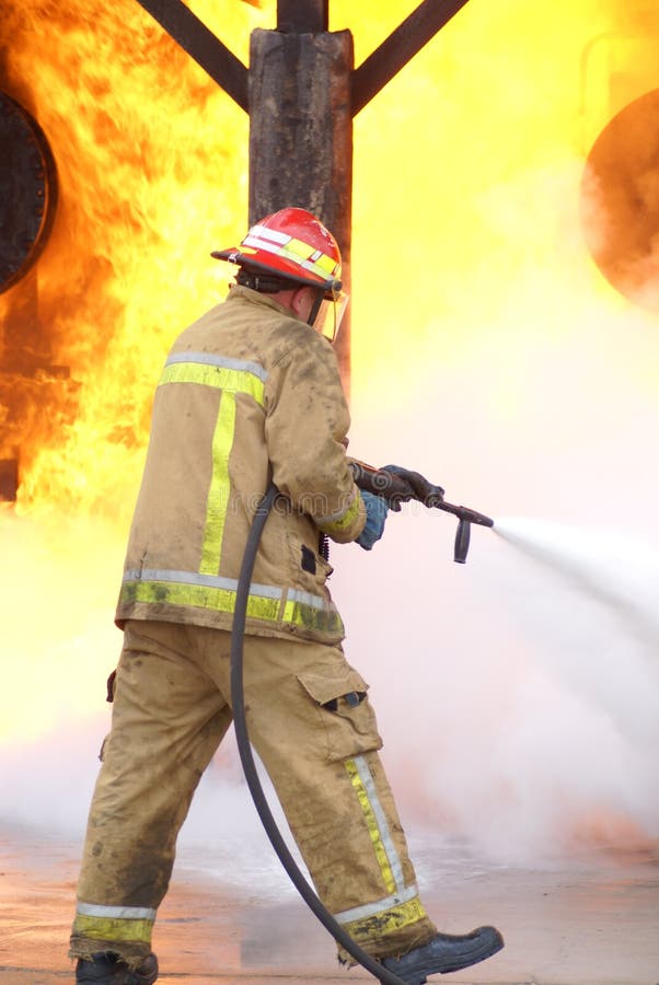 Firefighter in Action, Fighting Large Blaze Stock Image - Image of ...