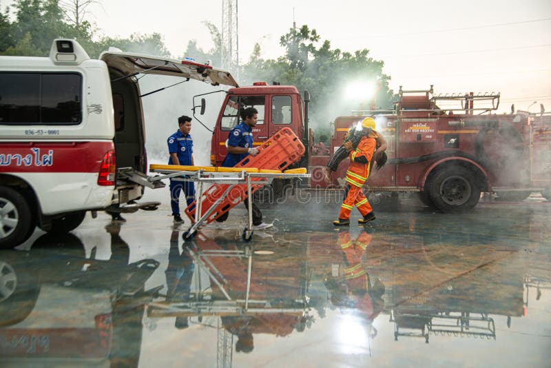 Firefighters Helping a Man Leave the Scorched and Smoky Place ...