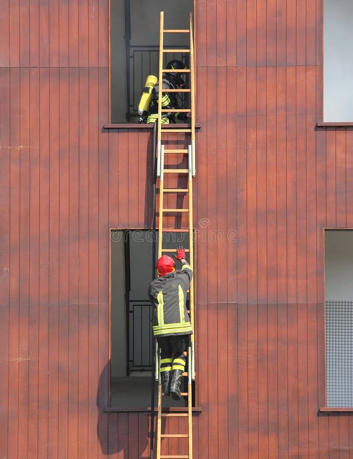 Firefighters with Ladder To Reach the Upper Floors of the Build Stock ...
